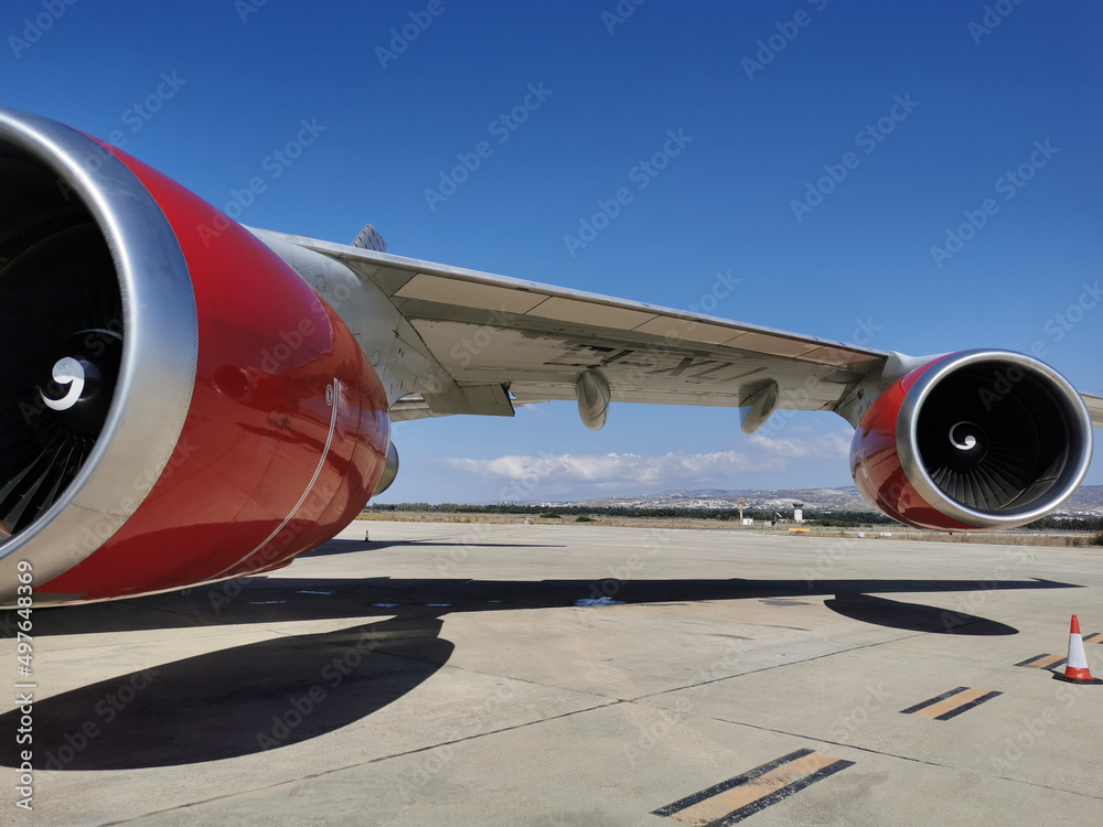Two red aircraft engines on the wing of an airplane standing in Paphos ...