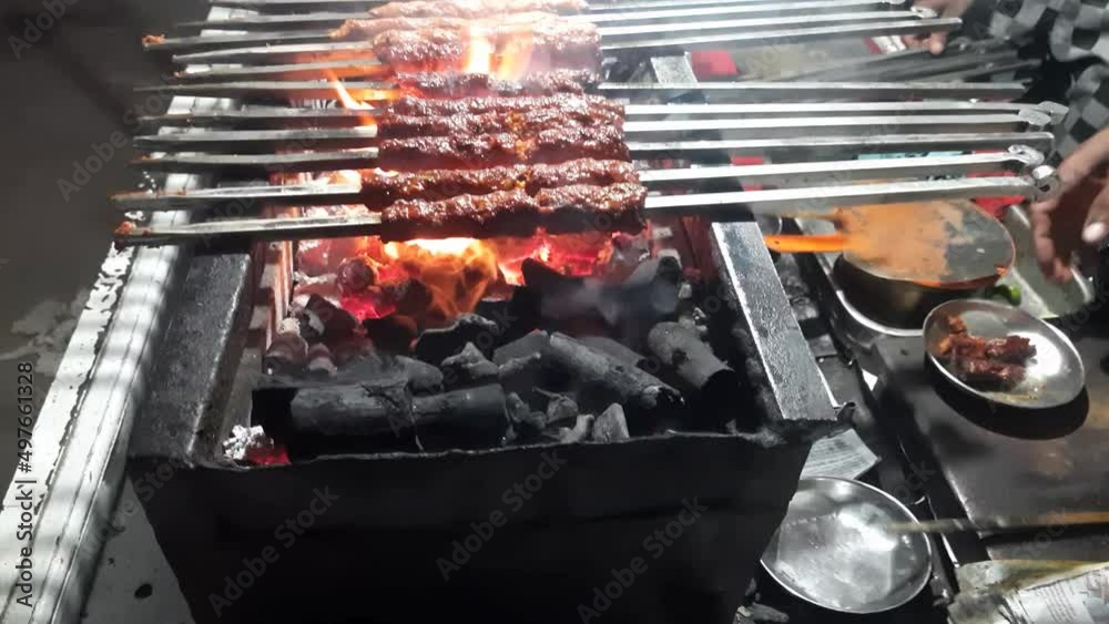 Close up of mutton seekh kabab being amazingly cooked over a coal ...