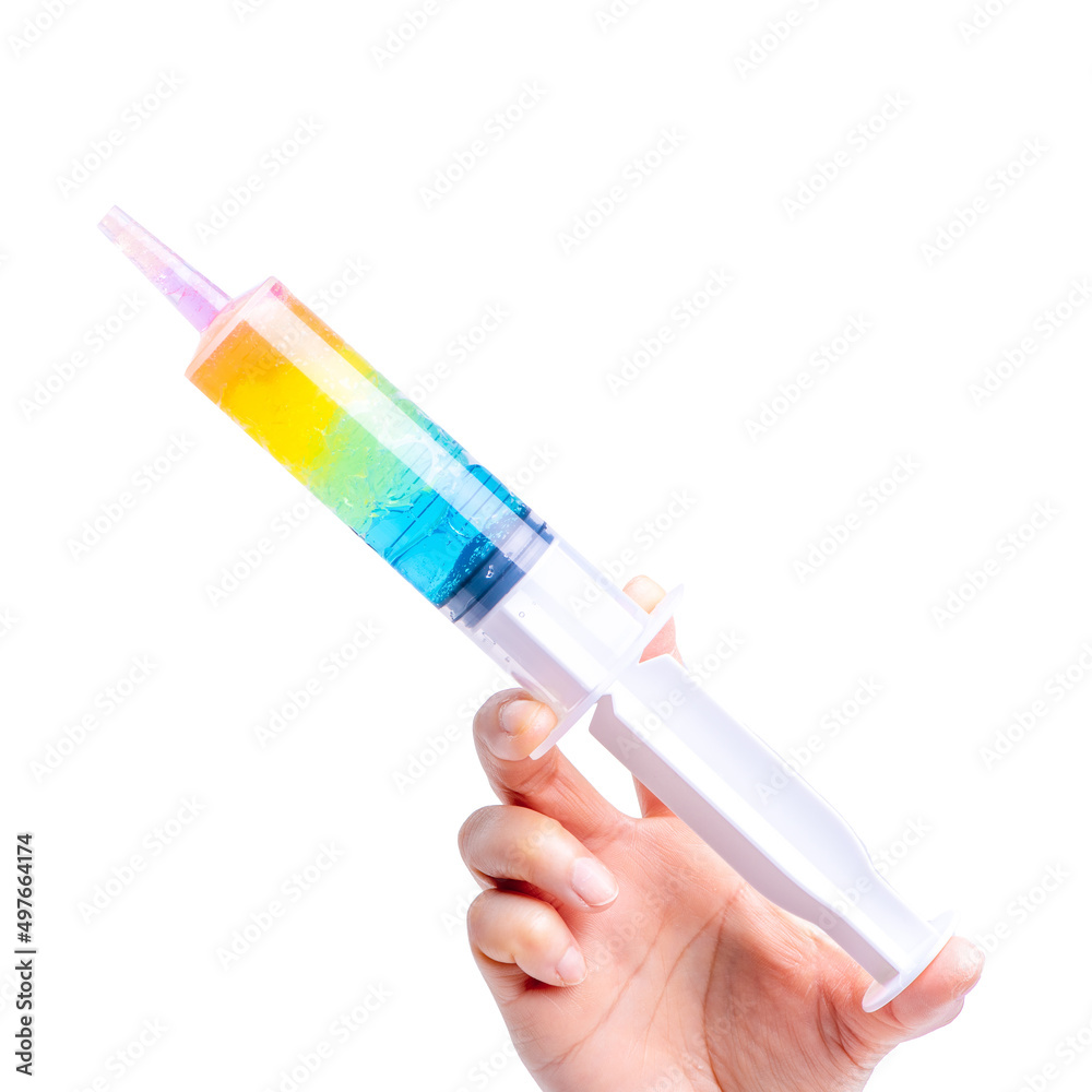 Injection concept. Hand holding multi color rainbow syringe on white ...