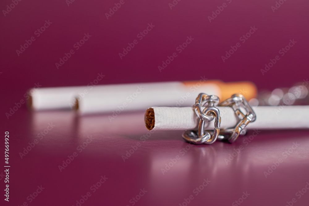 Nicotine addiction. Three cigarettes rewound by a chain Stock Photo ...