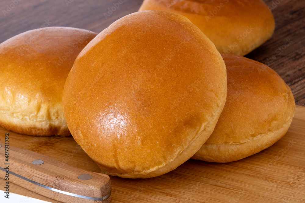 Fresh buns isolated on wooden background Stock Photo | Adobe Stock