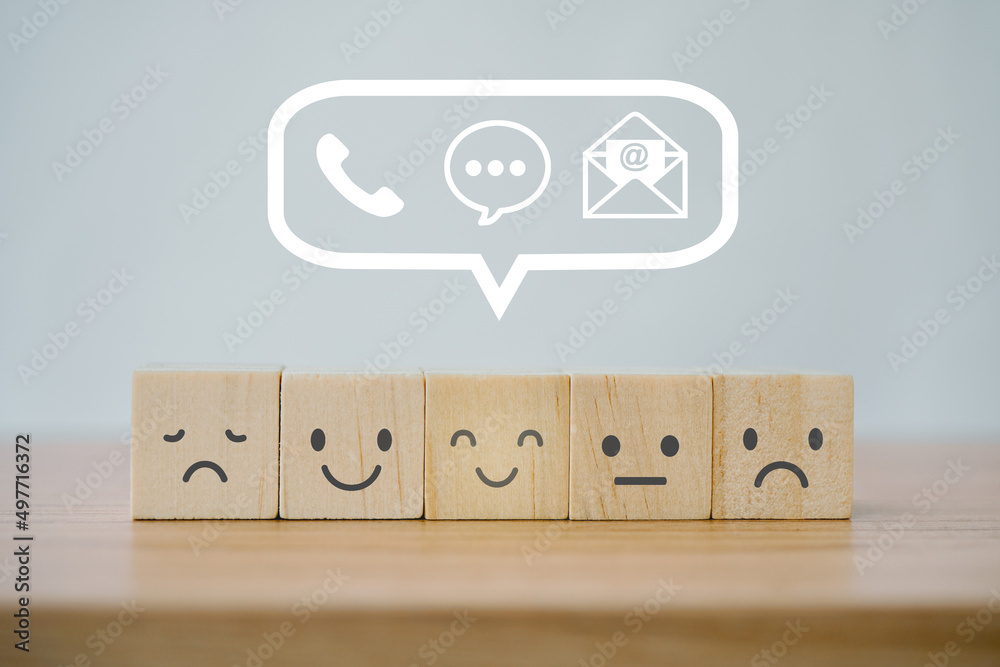 emoticon on wooden cube blocks with contact us sign above for happy ...