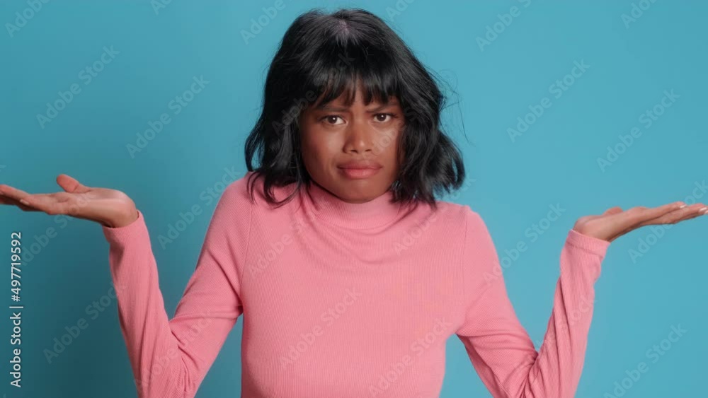 Young attractive embarrassed ethnic Asian woman shows bewilderment ...