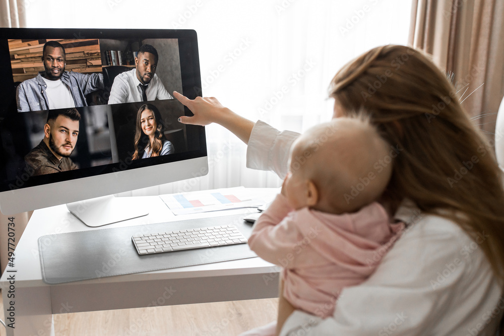 Lovely mother in maternity leave engaged in remote work or study at ...