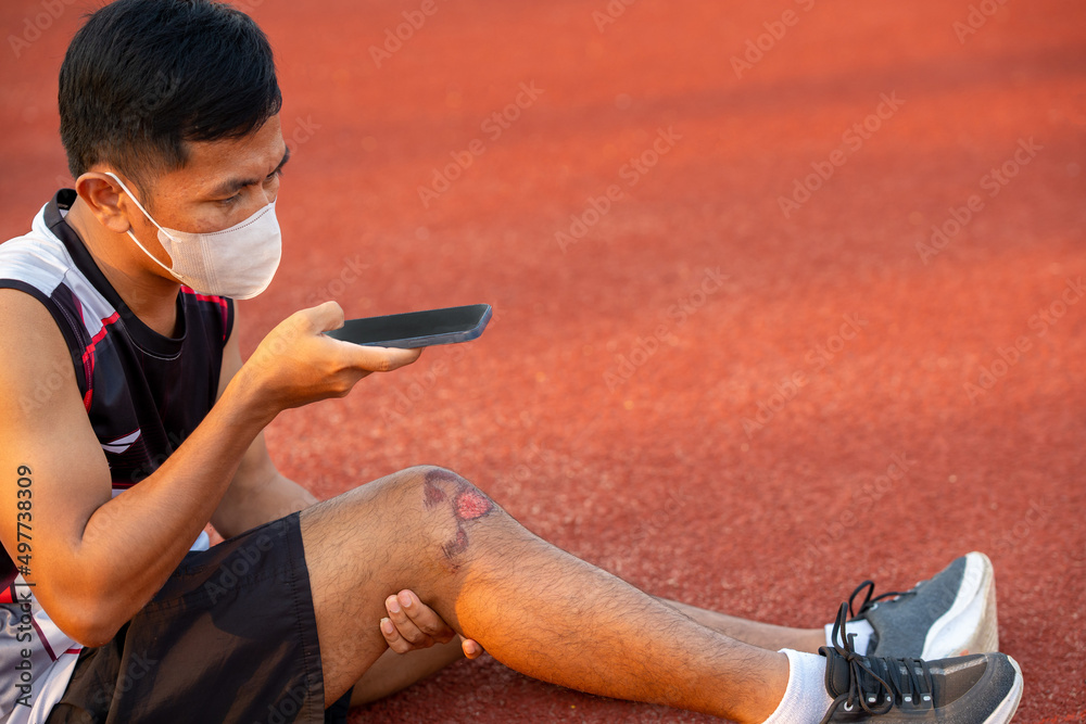 A man's leg suffered a large wound from a fall while jogging outdoors ...