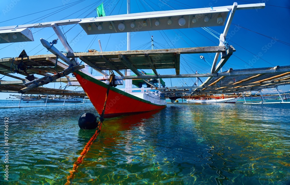 Traditional indonesian fishing boat the jukung floating in port of ...
