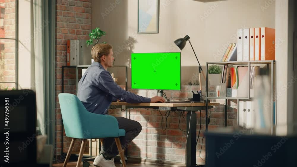 Young Handsome Man Working from Home on Desktop Computer with Green ...