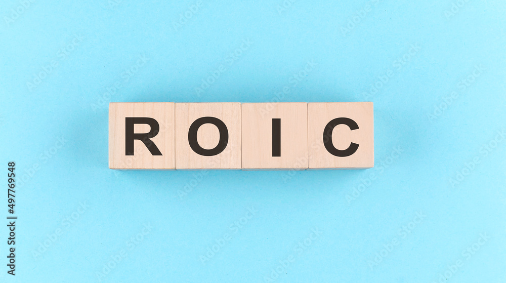 Wooden cube block with text ROIC stands for Return On Invested Capital ...