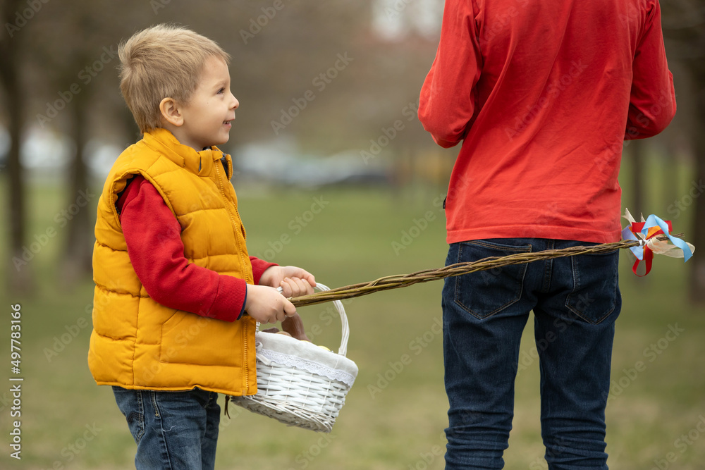 Cute preschool child, whipping his sister on Easter with twig, braided ...