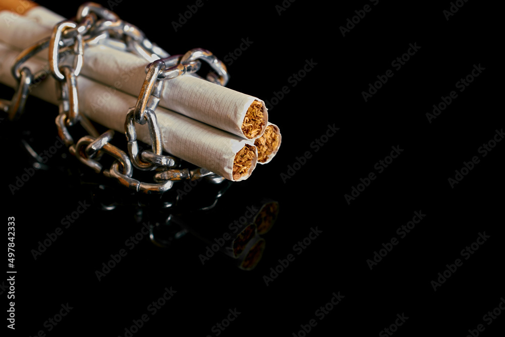 Nicotine addiction. Three cigarettes rewound by a chain Stock Photo ...
