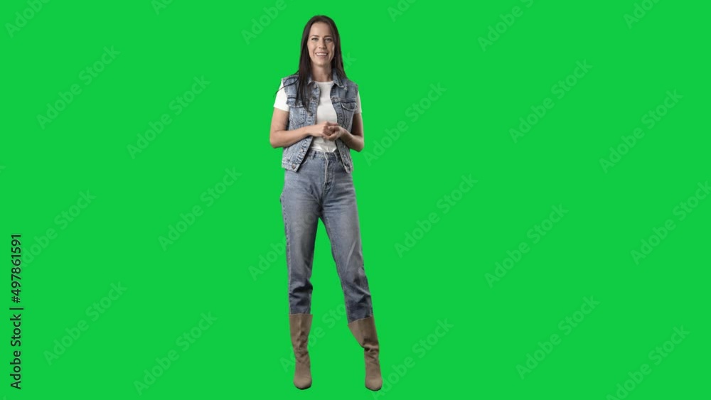 Vidéo Stock Pretty young woman in jeans talking and announcing looking ...