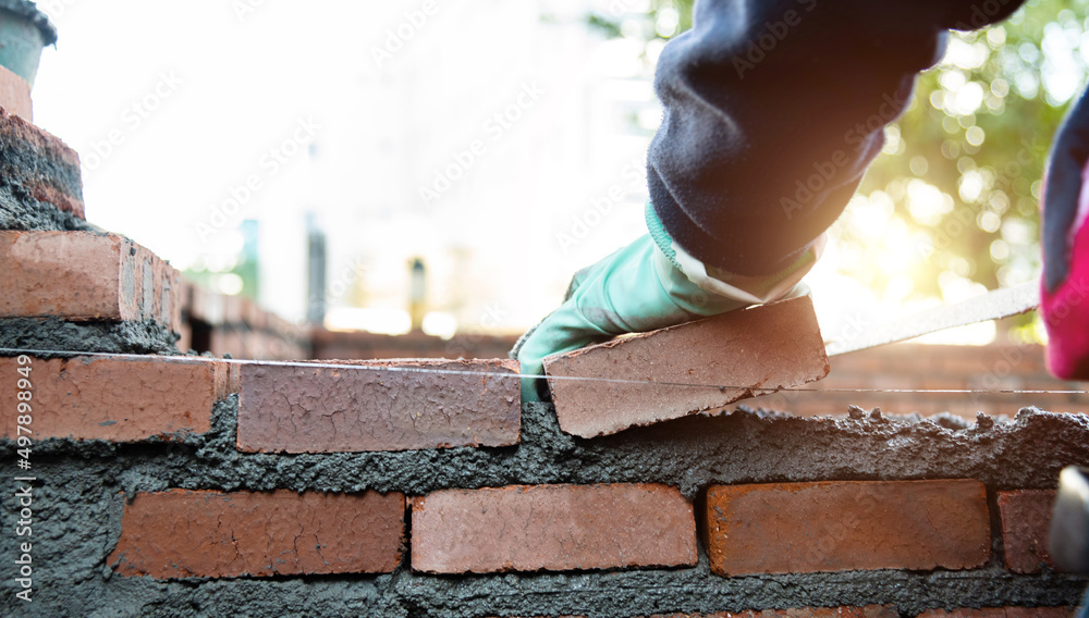Close up of bricklayer building walls Stock Photo | Adobe Stock