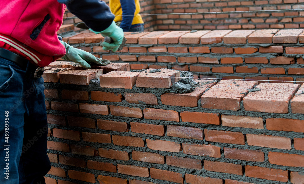 Close up of bricklayers building walls Stock Photo | Adobe Stock