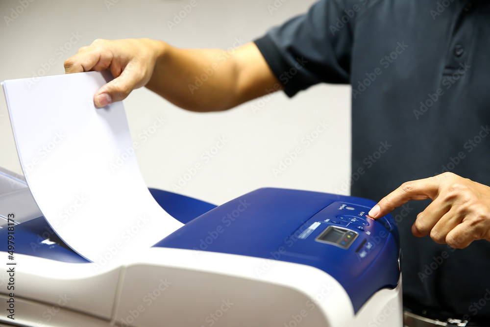 Technician hand press button and load paper in tray to using ...