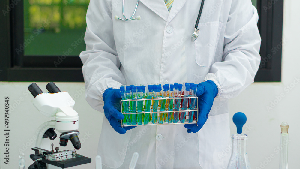 Laboratory scientists work with in vitro liquid test tubes for ...