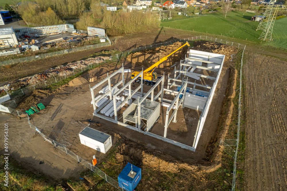 the basic structure of an industrial building is erected on a ...