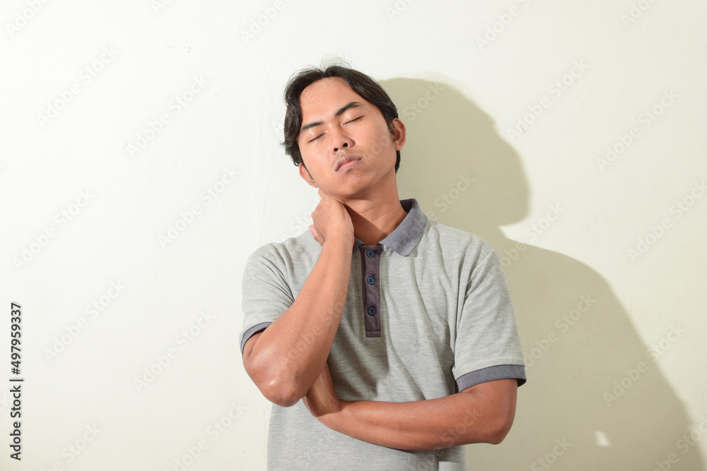 illustration of asian man neck pain. Indonesian man poses holding the ...