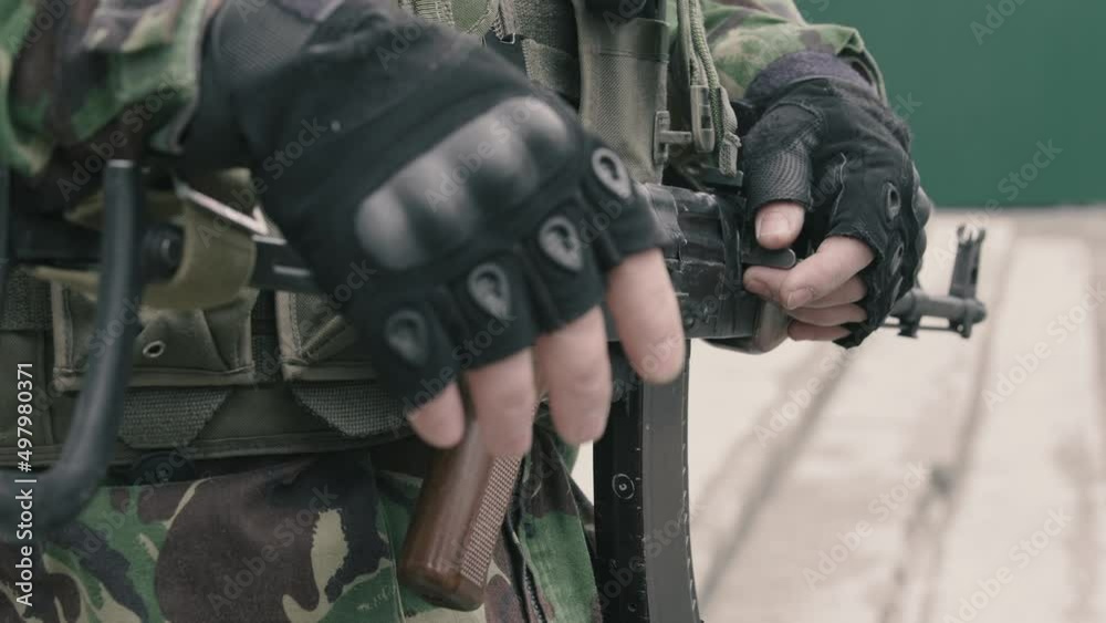 people with weapons in their hands. soldiers in camouflage military ...