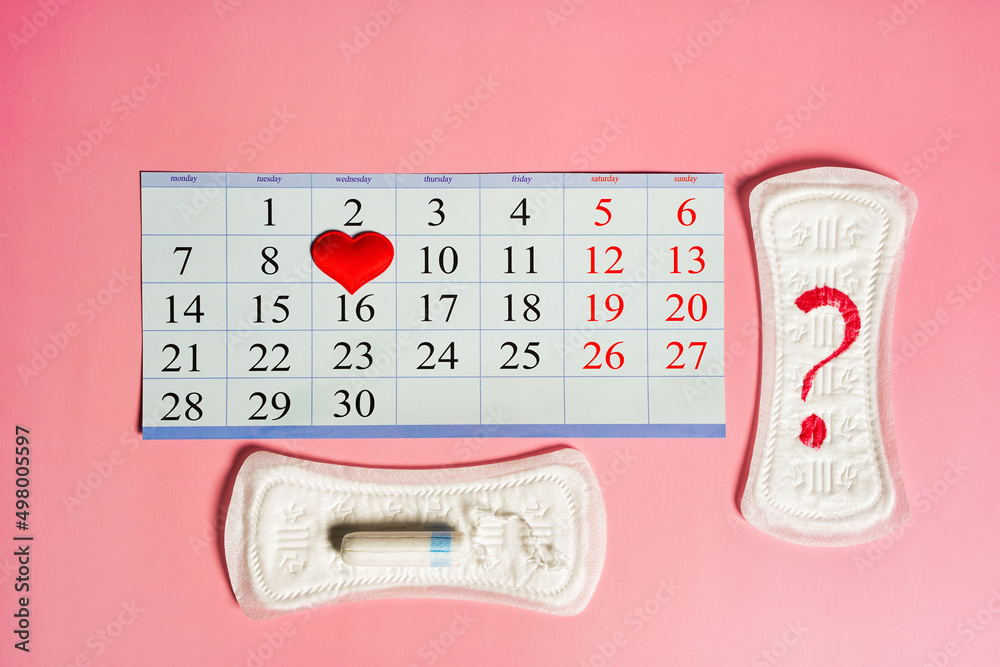 Menstruation days products, red heart and calendar with red marked ...