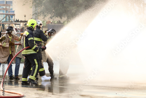 Firefighters using Twirl water fog type fire extinguisher to fighting ...