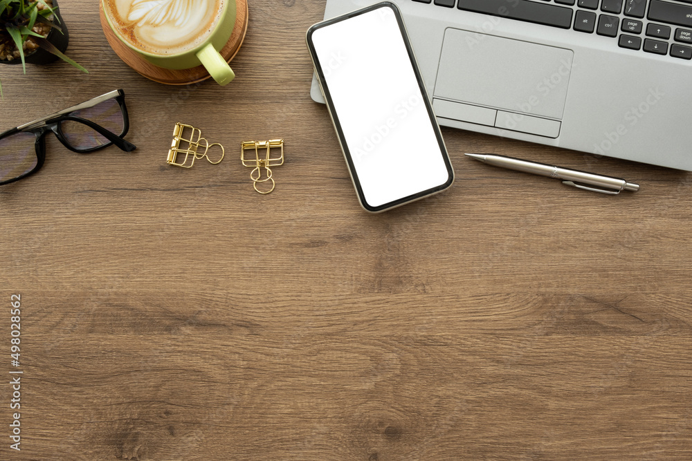 Smartphone with blank empty mockup screen is on top of laptop computer ...