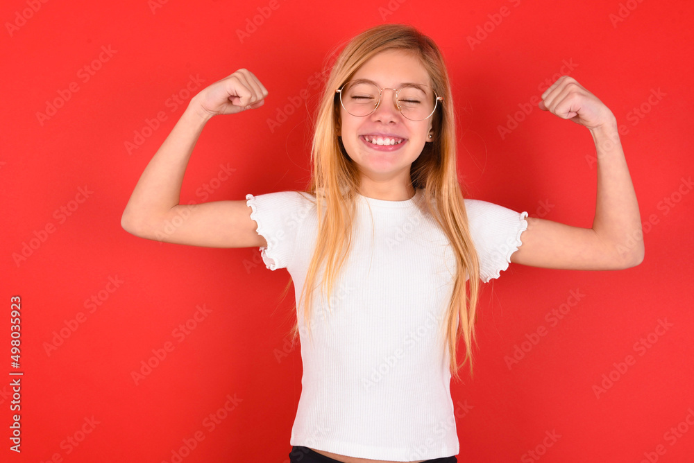Strong powerful blonde little kid girl wearing white t-shirt over red ...