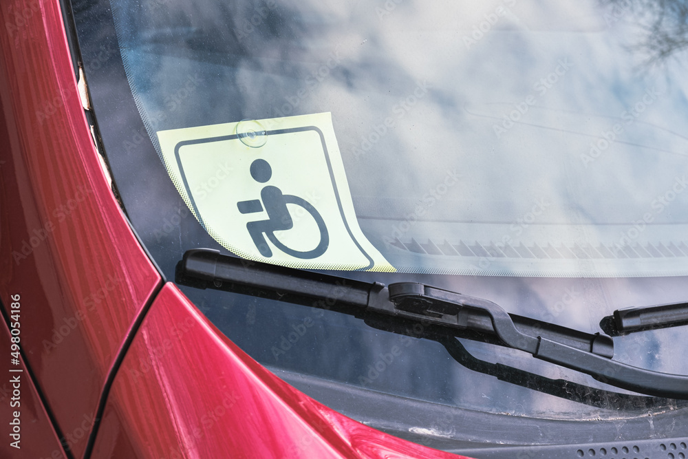 Disabled person driving sign on the windshield of a car. Identification ...