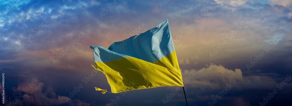 Flag of Ukraine on dramatic cloudy sky for wide banner or billboard ...