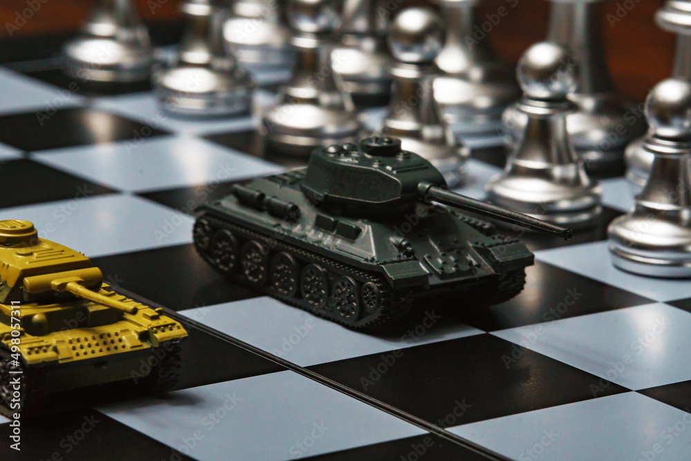 Toy tanks with chess on chessboard. Concept of military strategy. Stock ...