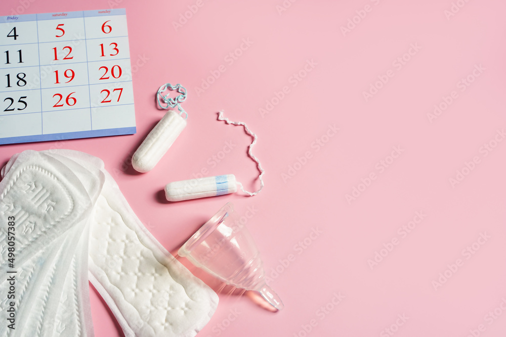 Menstruation days products, calendar with red marked dates of ...