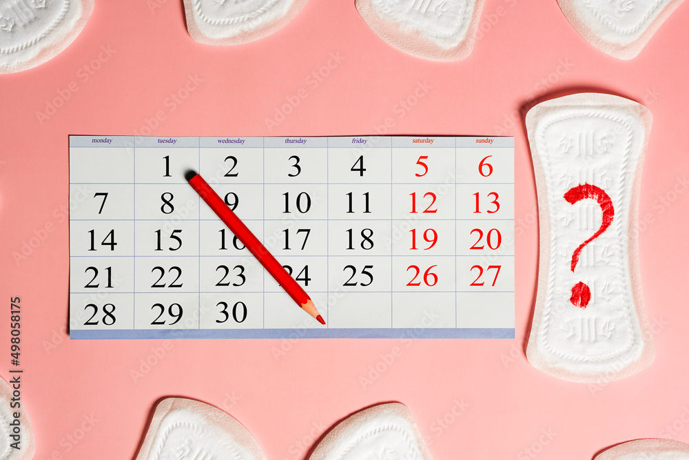 Menstruation days products, calendar with red marked dates of ...