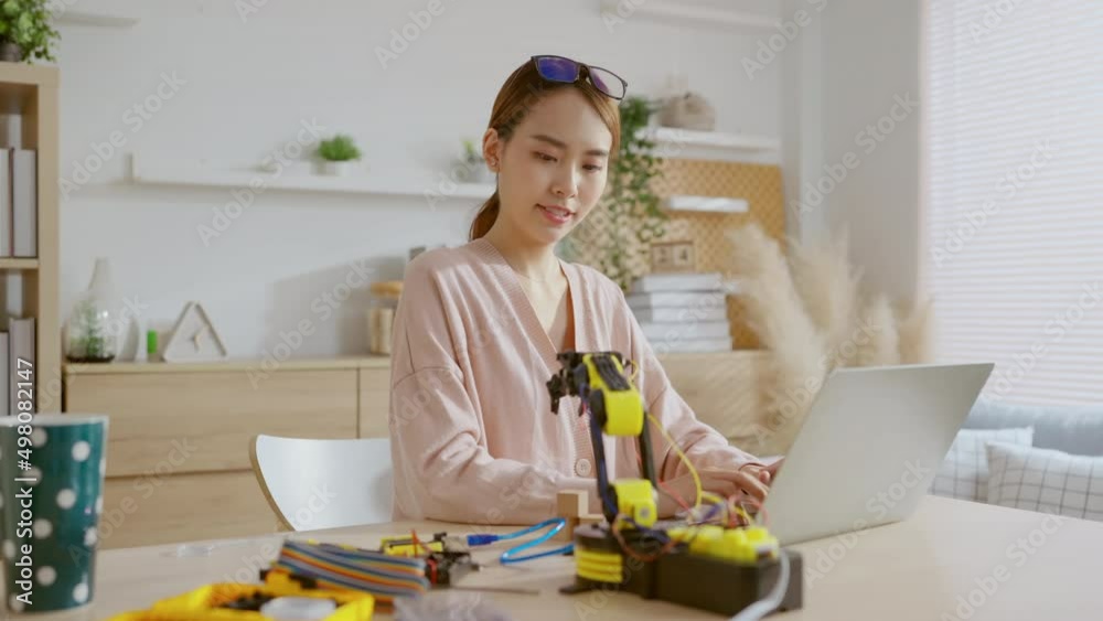 Video Stock Smart Asian Female Programer Learning Robot Arm Ai Coding Electronic Board Cable In