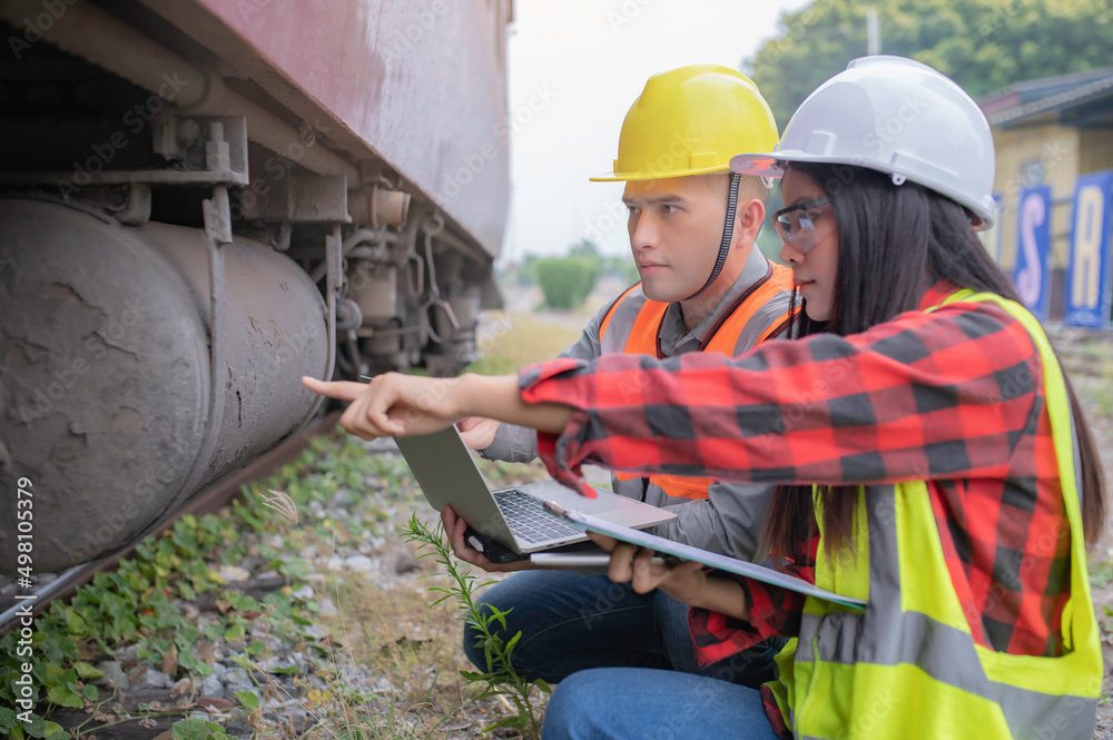 Two engineer working at train station,Work together happily,Help each ...