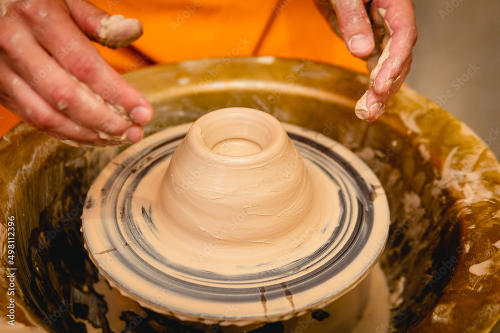 Potter working on potters wheel with clay. Process of making ceramic ...