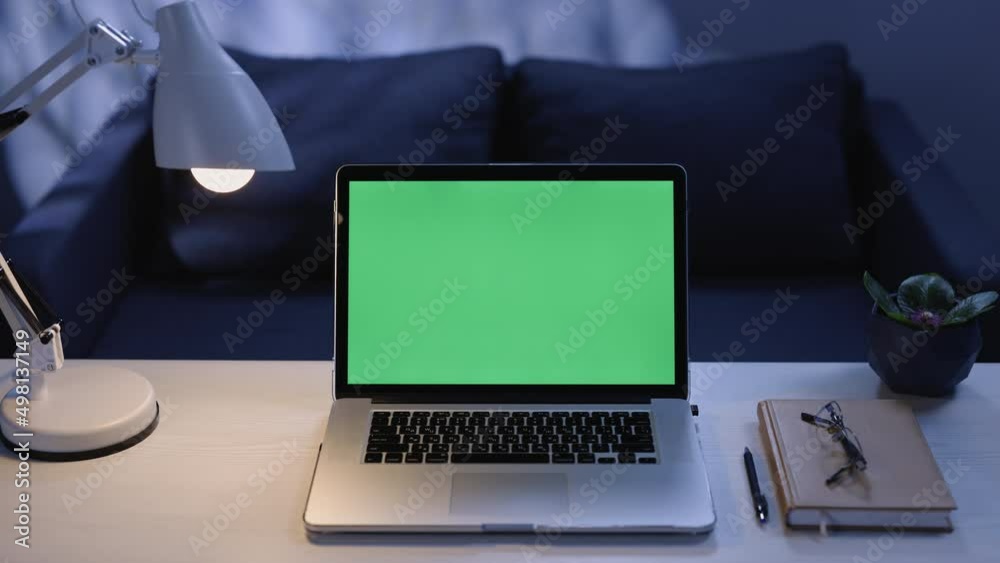 Modern laptop with mock up chroma key green screen on table of living ...