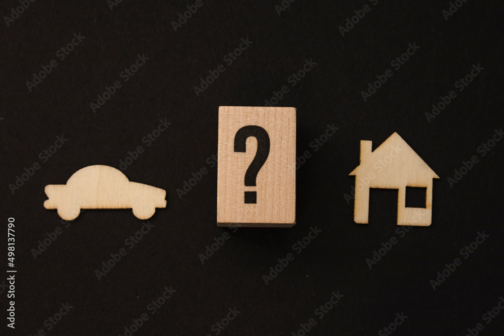 Wooden symbols, blocks on the black background car question mark house ...