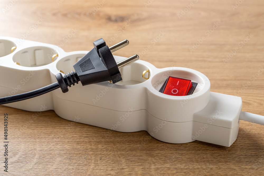 Fotka „Unplugged electric appliance plug over switched off white power ...