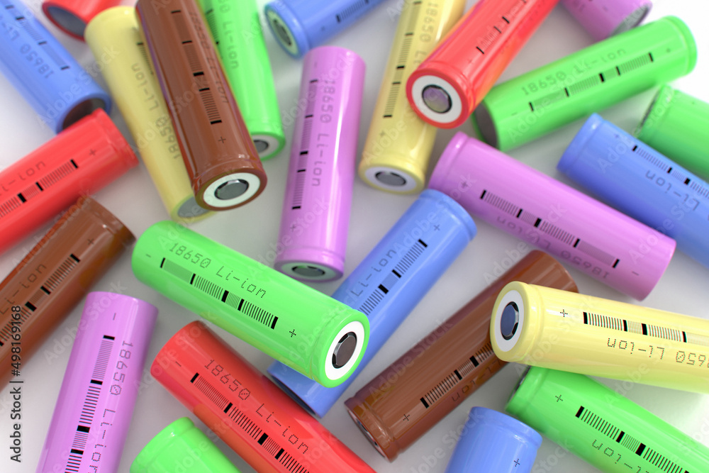 Lots of cylindrical 18650 lithium-ion batteries on a white table. Li ...