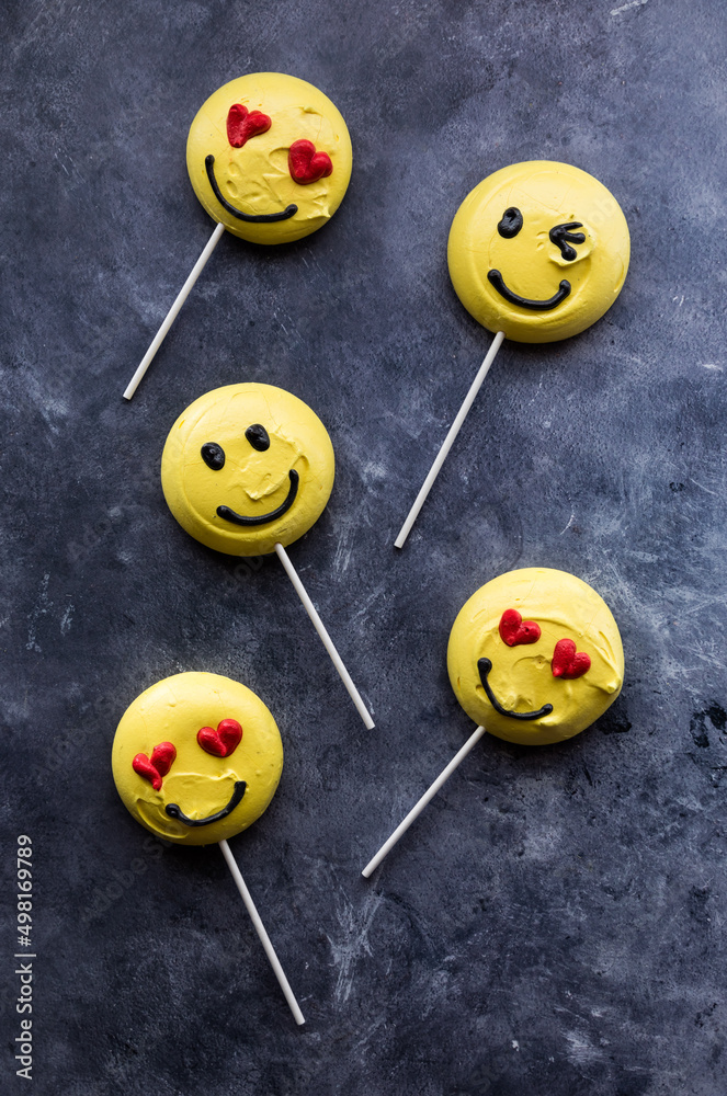 Smiley face emoticon merengue cookies with lollipop sticks. Stock Photo ...