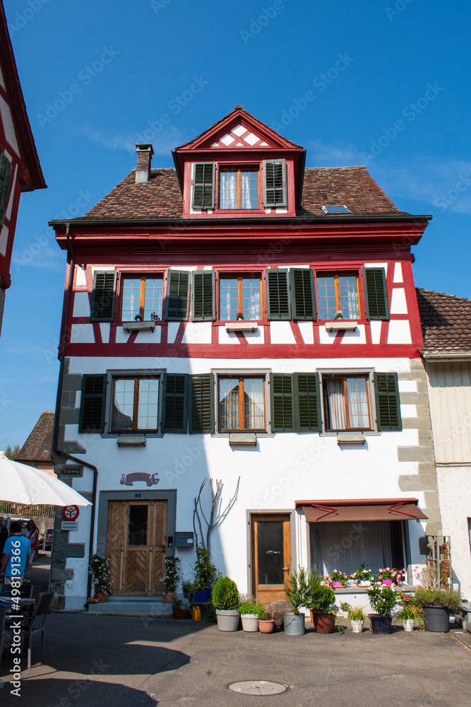Historic tenement house with white walls, red half timbered elements ...