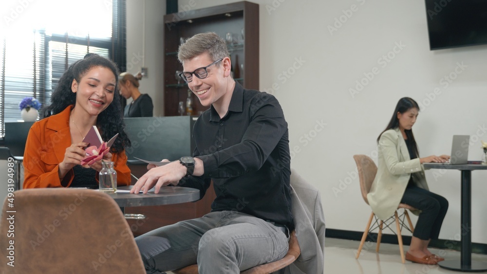 Business man and woman waiting at airport lounge talking together mean boarding pass and ...