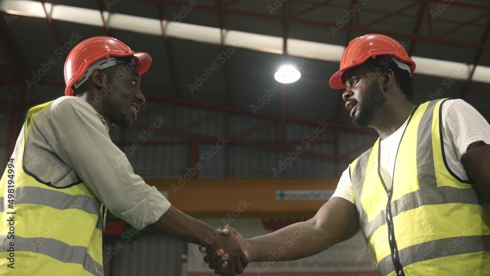 Two America worker black man wearing safety uniform with hardhat hand ...