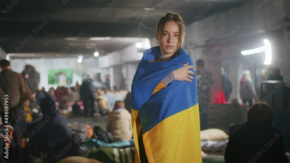 Portrait of a sad Ukrainian woman in a bomb shelter with the Ukrainian ...
