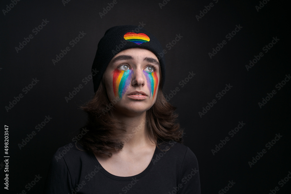Crying eyes with rainbow iris flag on colored face concept sadness and ...