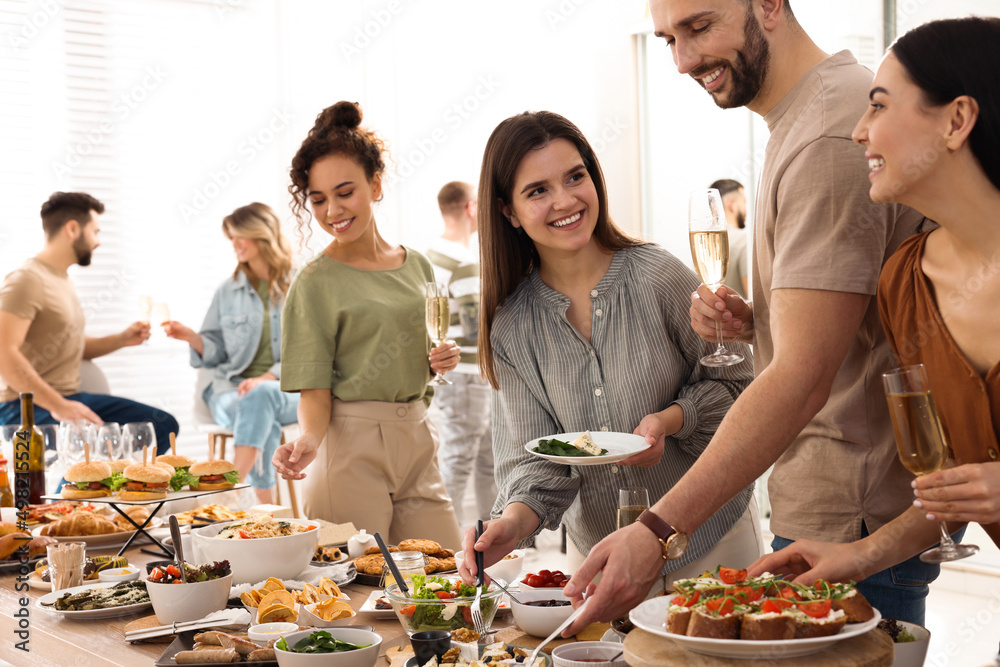 Group of people enjoying brunch buffet together indoors Stock Photo ...