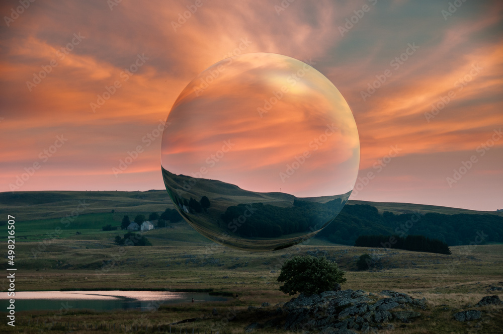 surreal sphere floating in the middle of a beautiful landscape ...