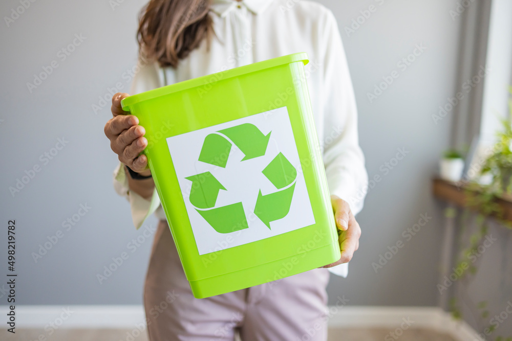 Young Asian woman with a crate for recycling. A woman collecting and ...