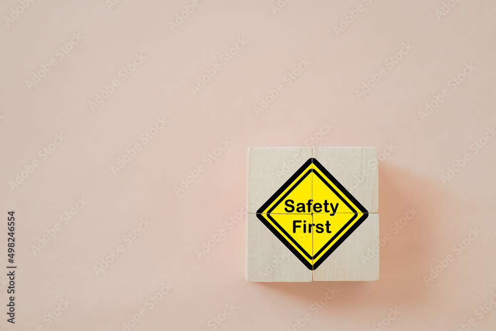 wooden cube block with safety first icon for work safety, caution work ...