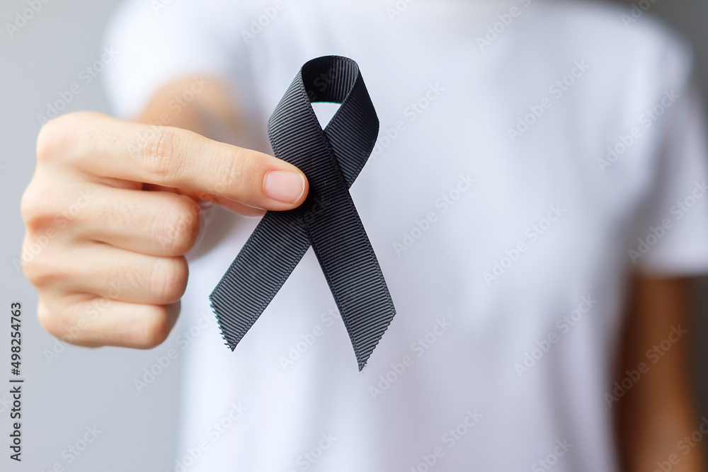 Woman holding black Ribbon for Melanoma and skin cancer, Vaccine injury ...