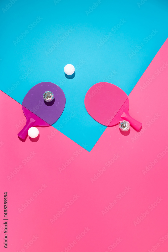 Party background with wo table tennis rackets with two white ping pong ...